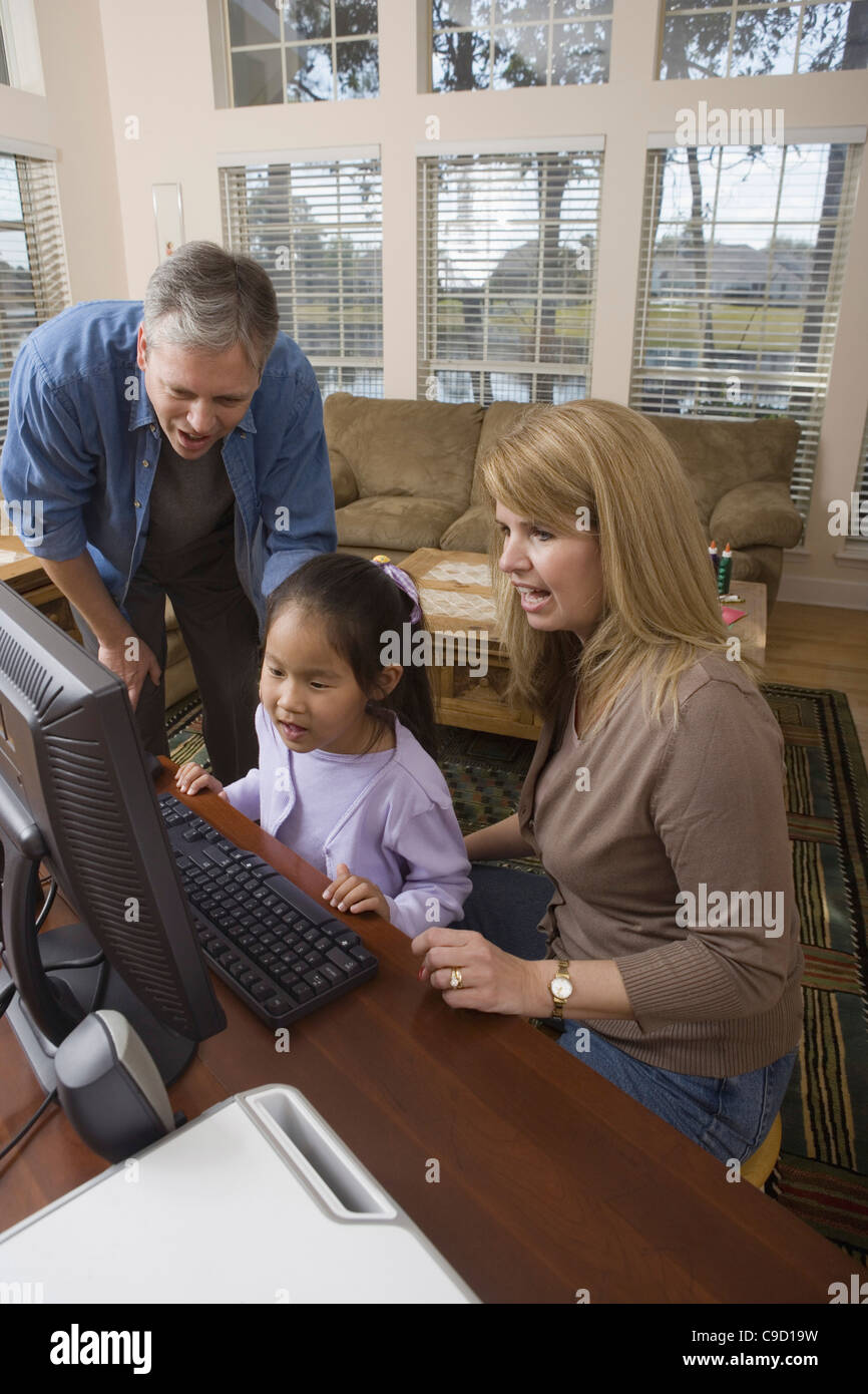 Three girls looking computer monitor hi-res stock photography and ...