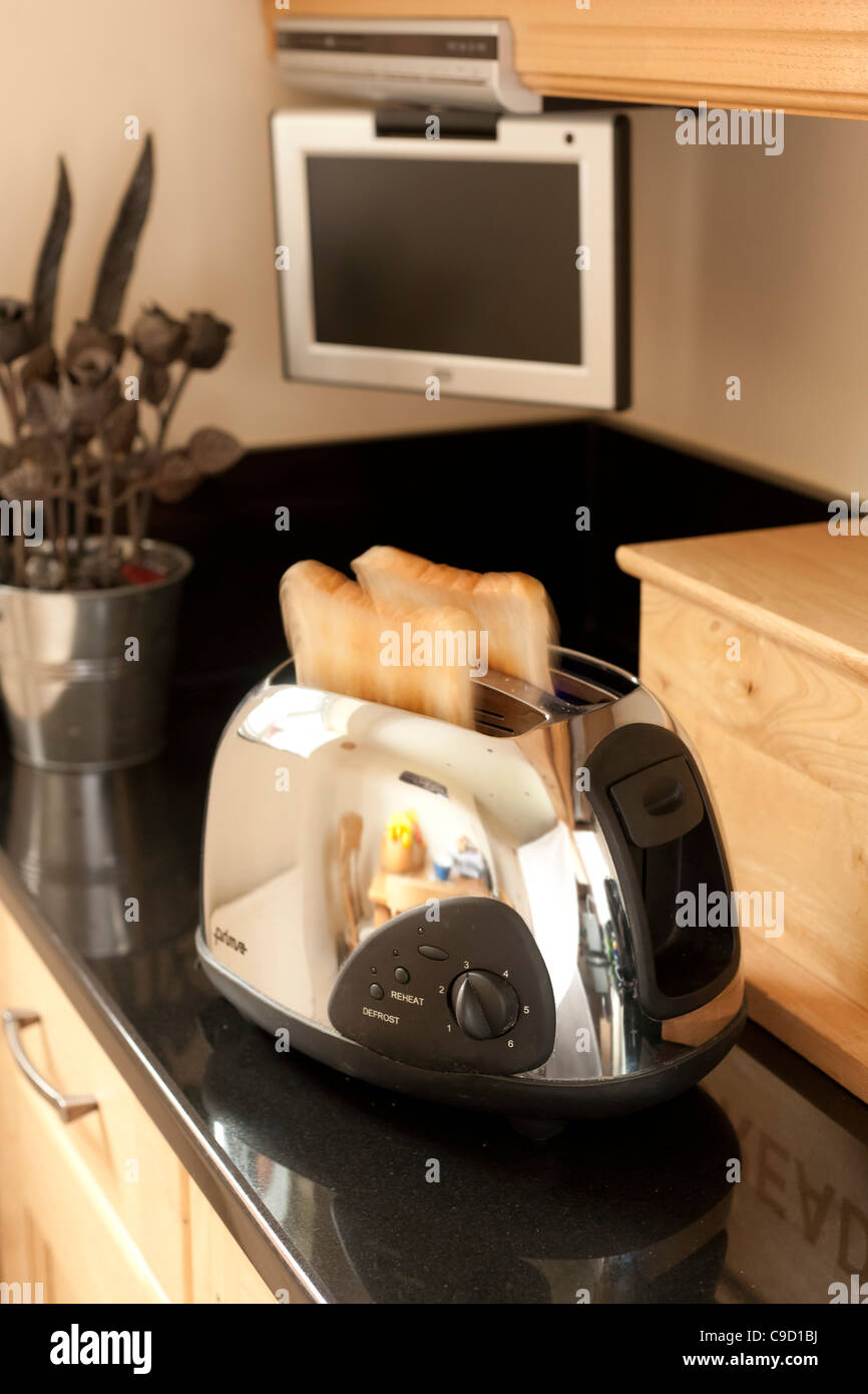 Fresh hot toast pops out of a toaster, ready for buttering. A slow ...