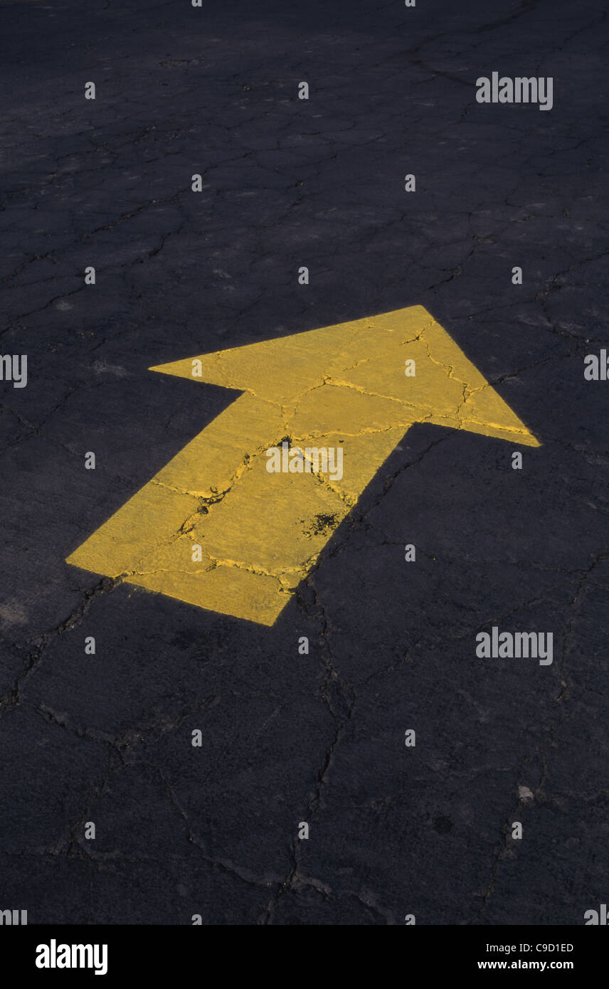 Arrow sign painted on a road Stock Photo - Alamy