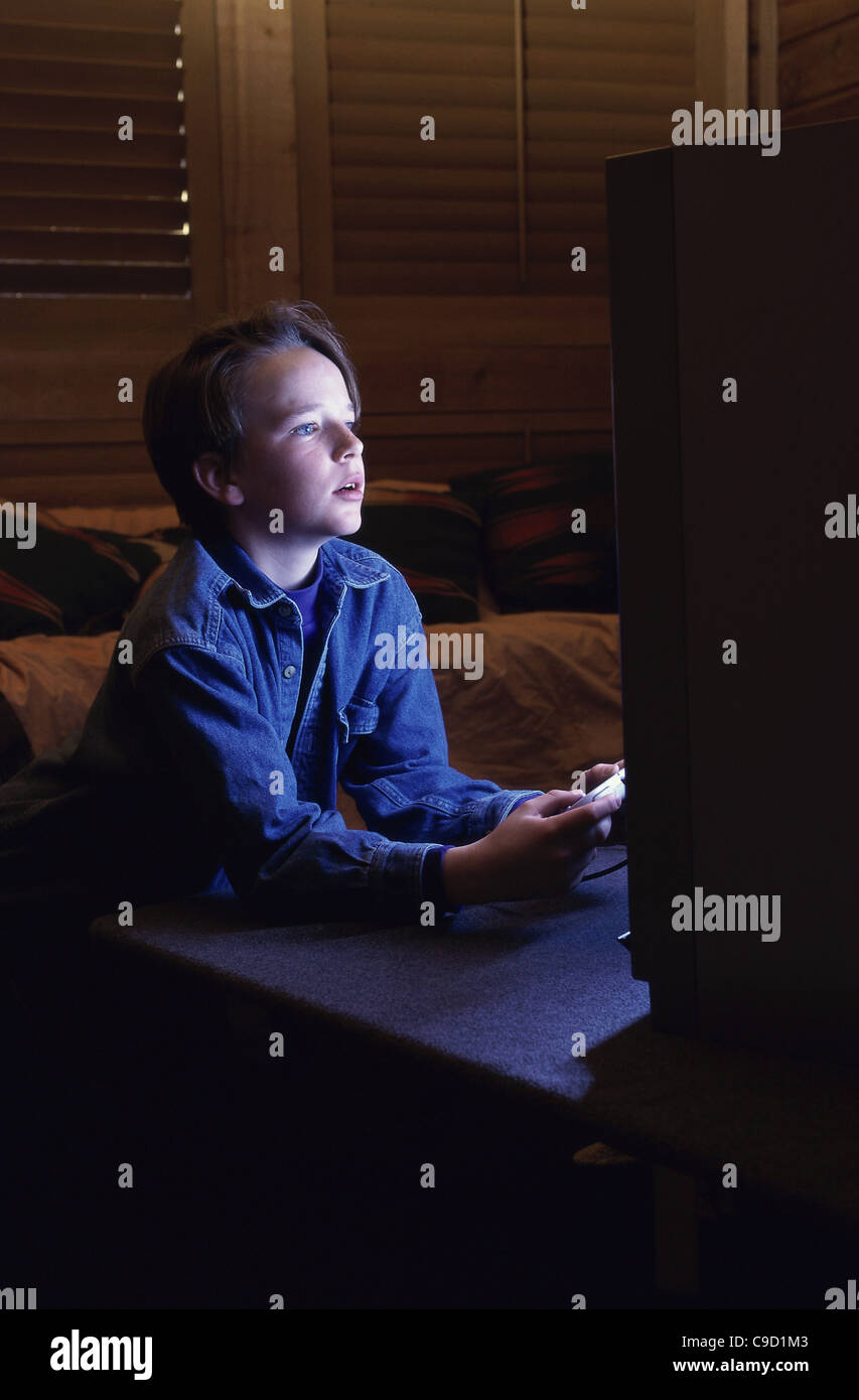 Side profile of a boy playing a video game hi-res stock photography and ...