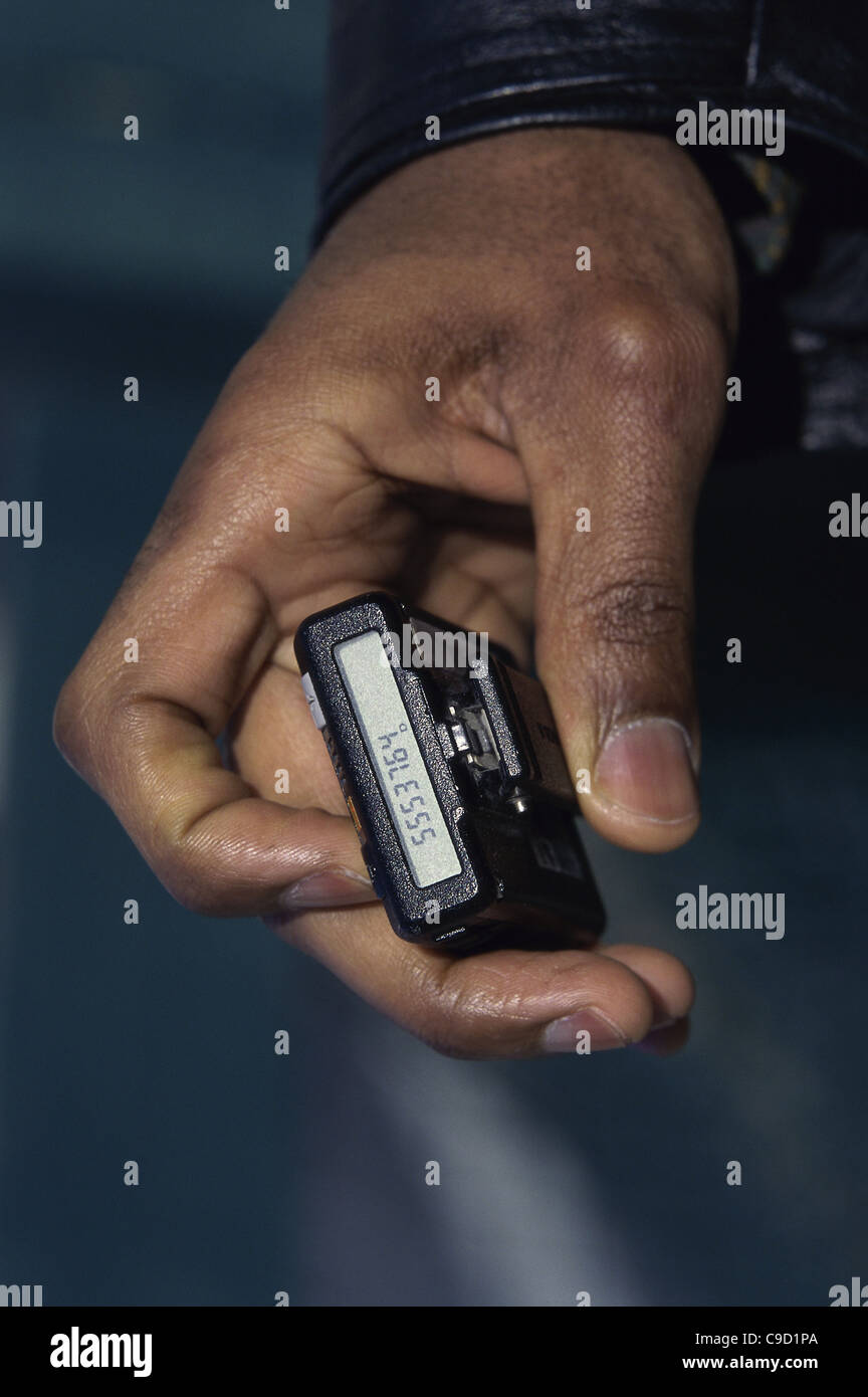 Person holding a pager Stock Photo - Alamy