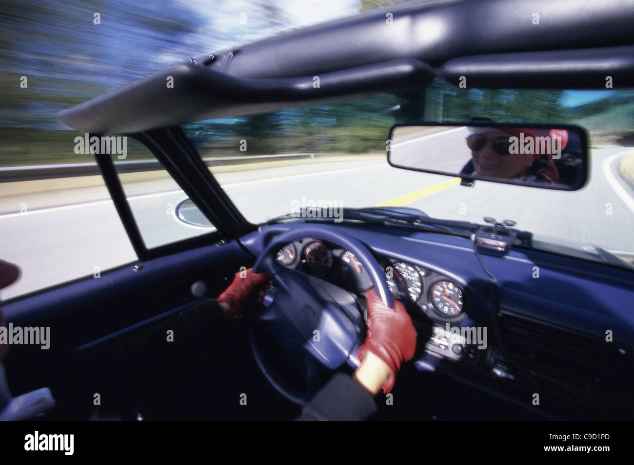 Person driving a convertible car Stock Photo - Alamy