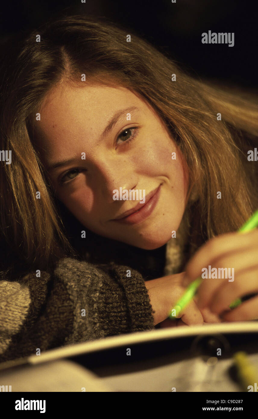 Portrait of a teenage girl writing on a notepad Stock Photo - Alamy