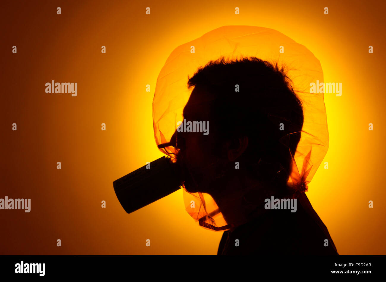 Man wearing emergency fire escape hood Stock Photo - Alamy