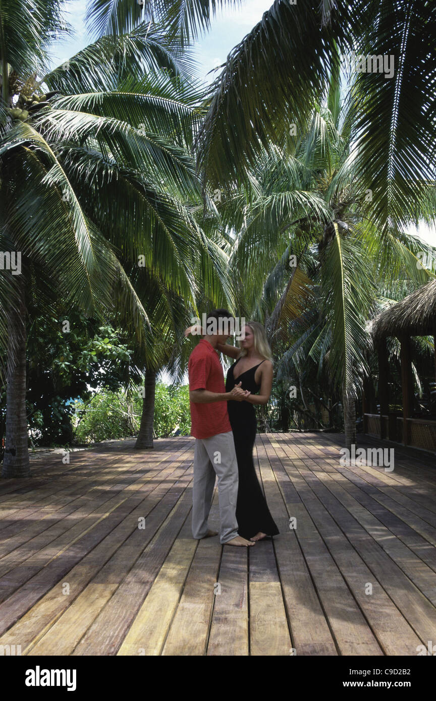 Side profile of a young couple dancing, Maldives Stock Photo - Alamy