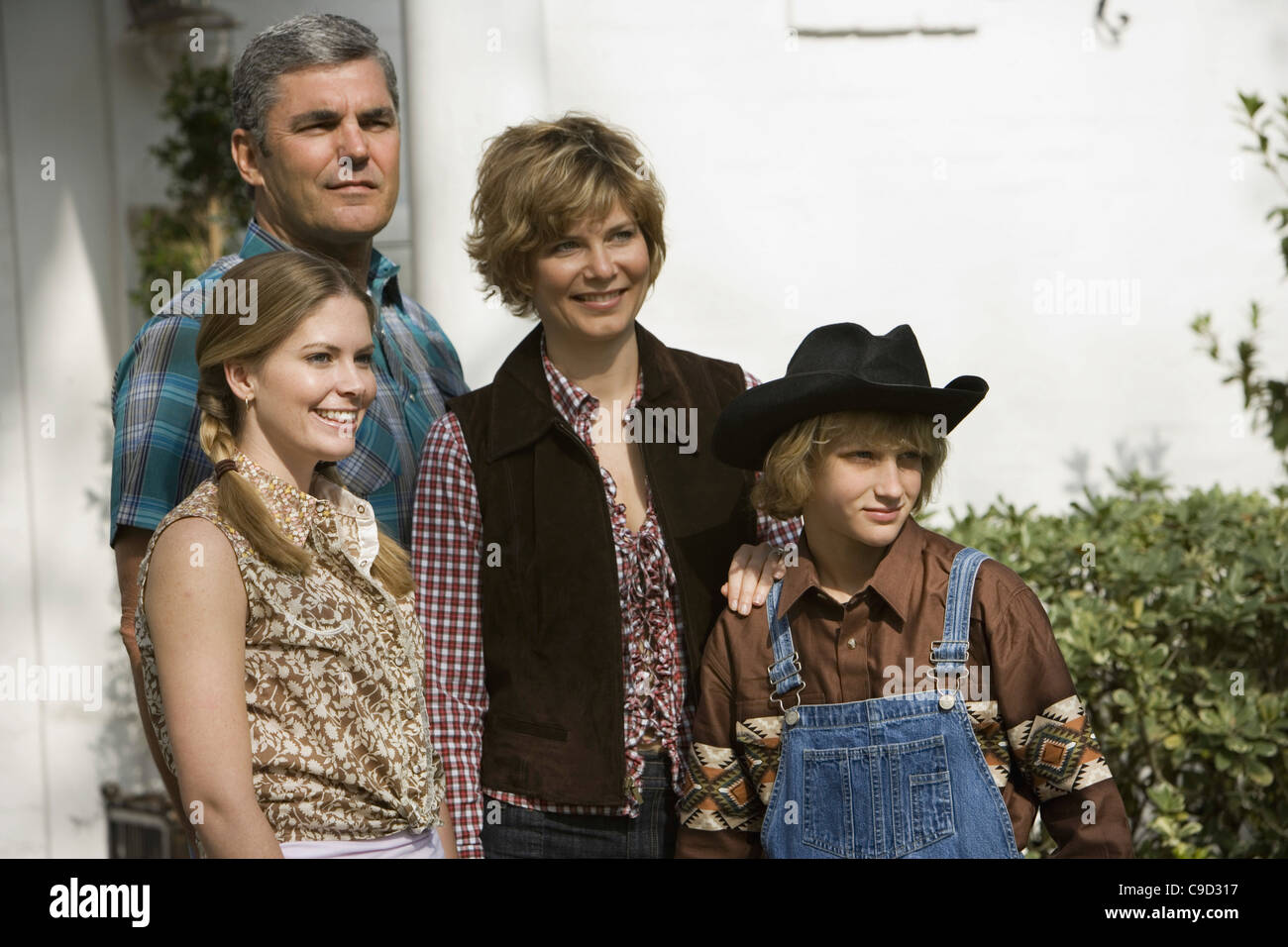 Family in country clothes standing together Stock Photo - Alamy