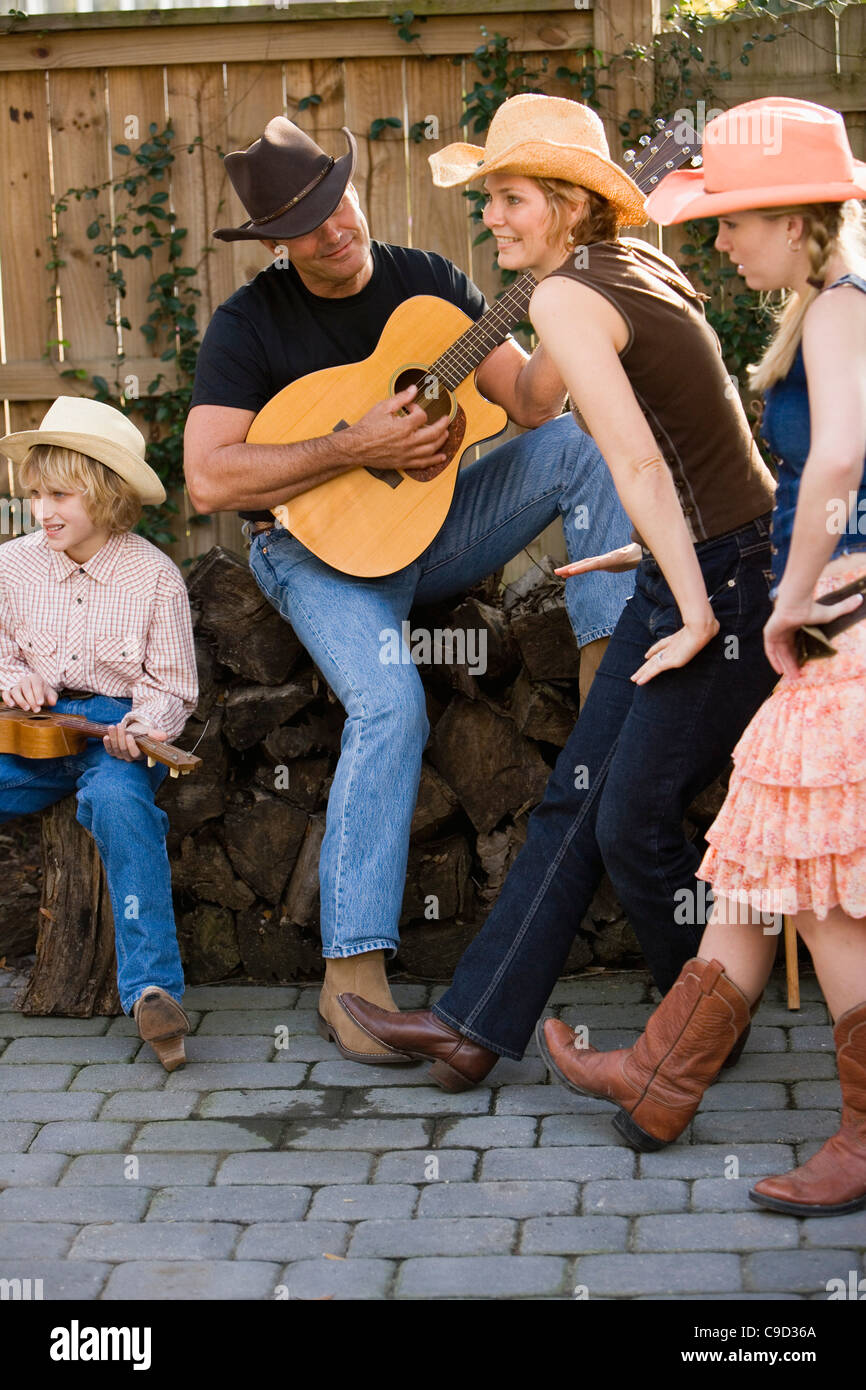 Family playing country music and dancing Stock Photo - Alamy