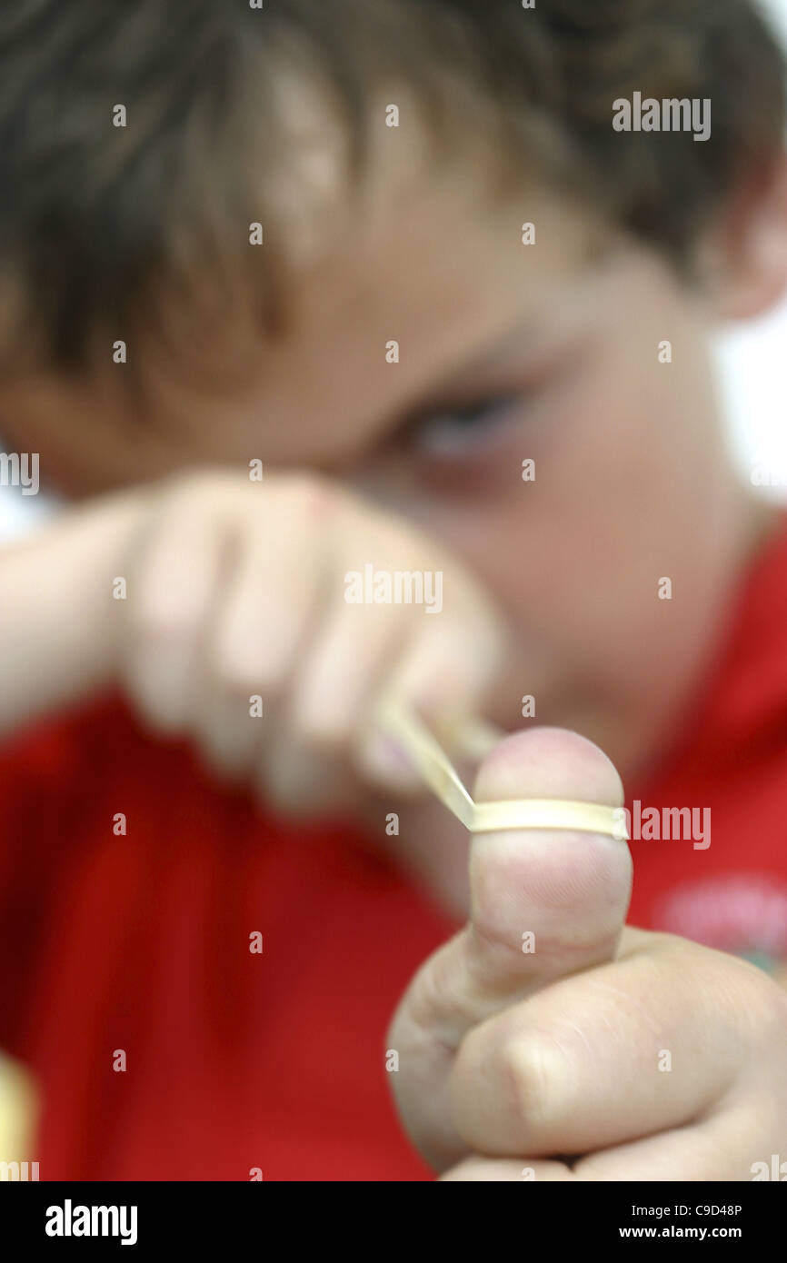 Boy stretching rubber band hi-res stock photography and images - Alamy