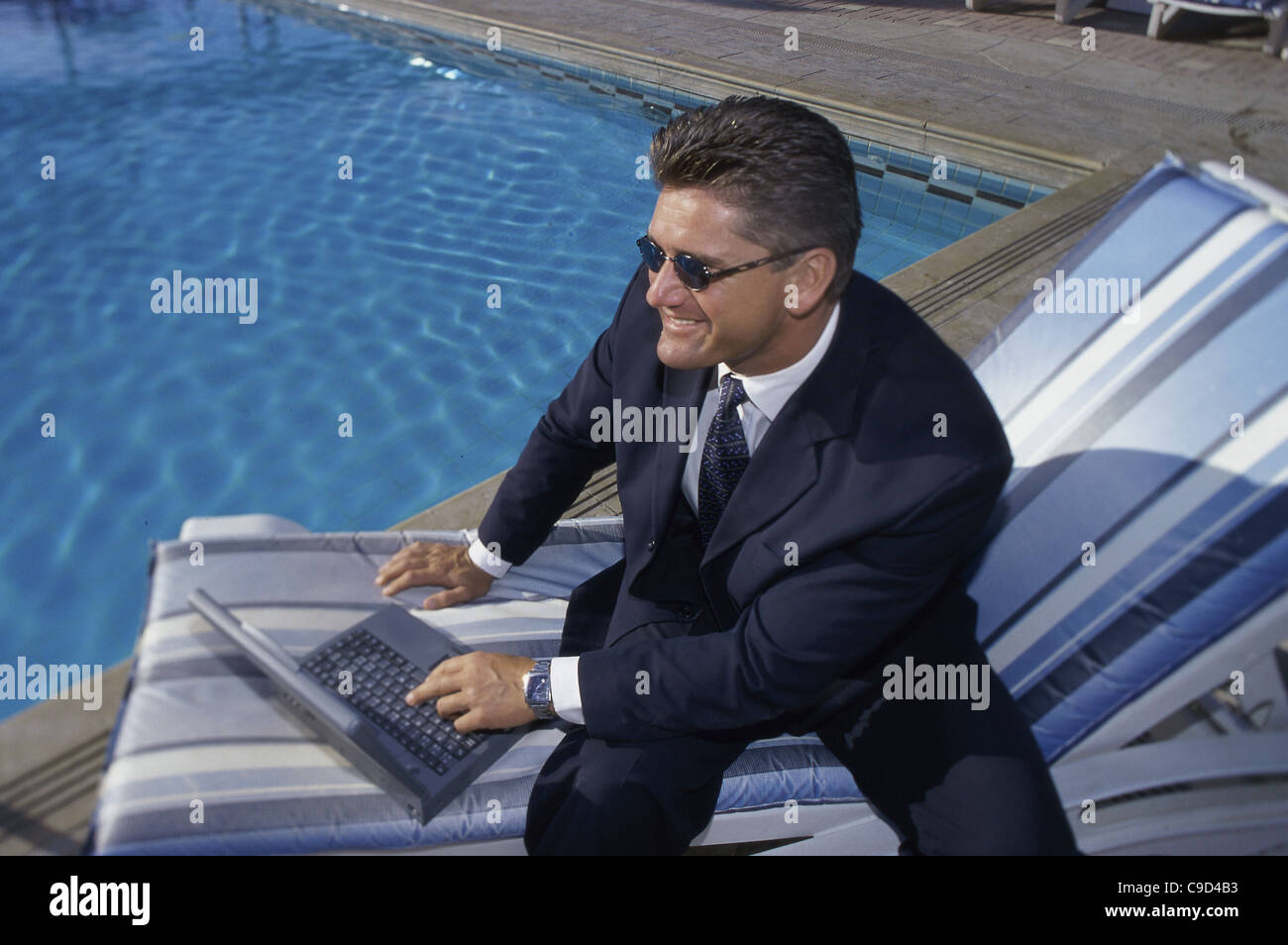 Man working sitting swimming pool hi-res stock photography and images ...