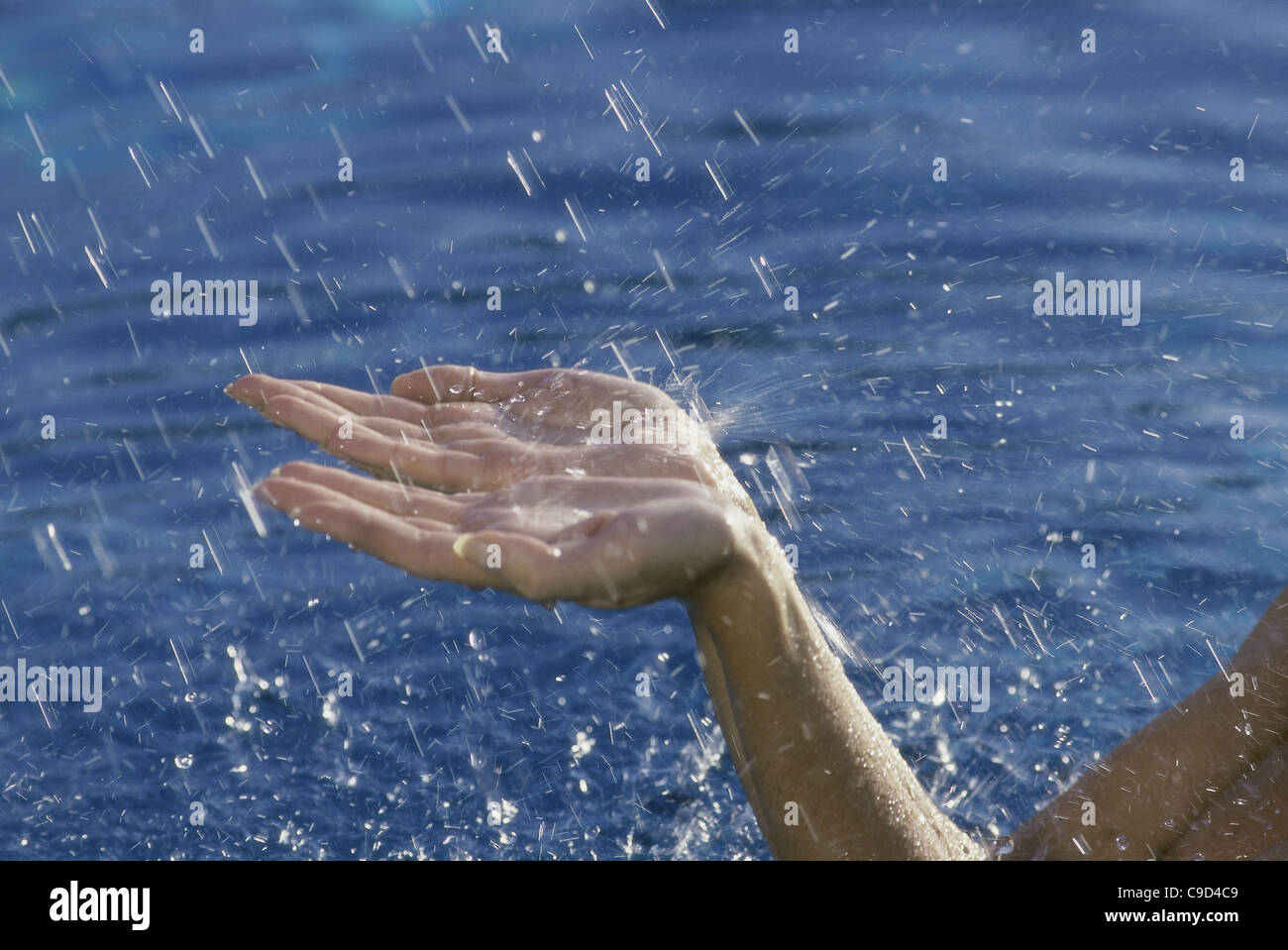Person's hands catching rain drops Stock Photo - Alamy