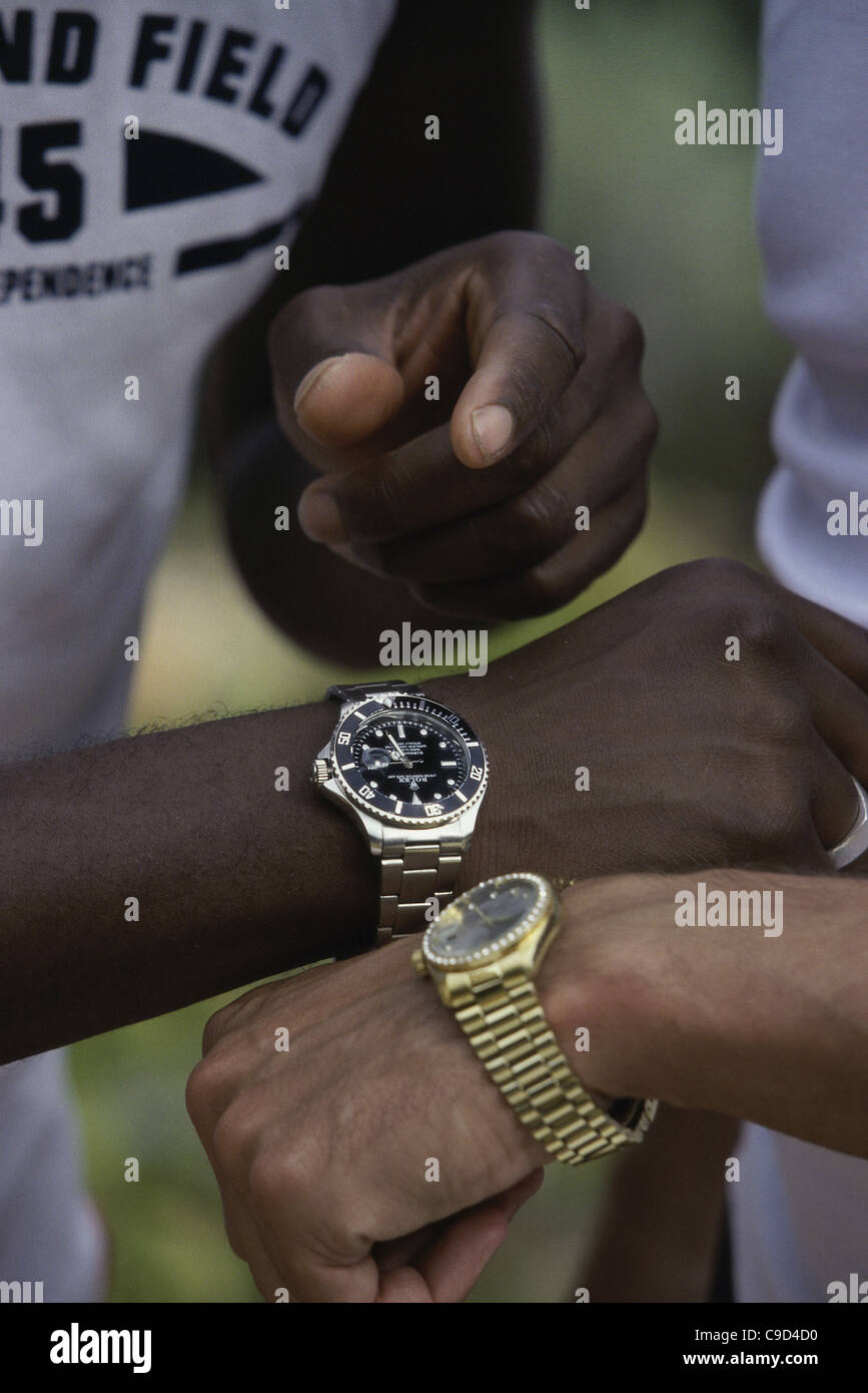 Two people synchronizing their wristwatches Stock Photo - Alamy