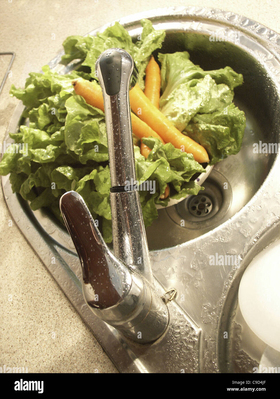 Vegetables in a sink Stock Photo - Alamy