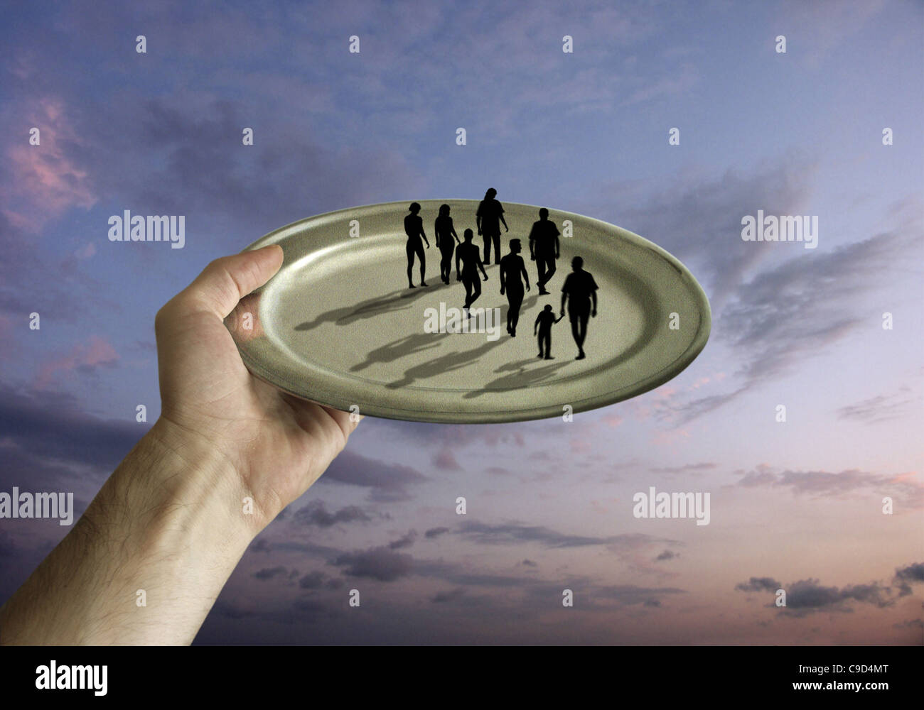 Person's hand holding a plate with silhouette of people standing on it ...