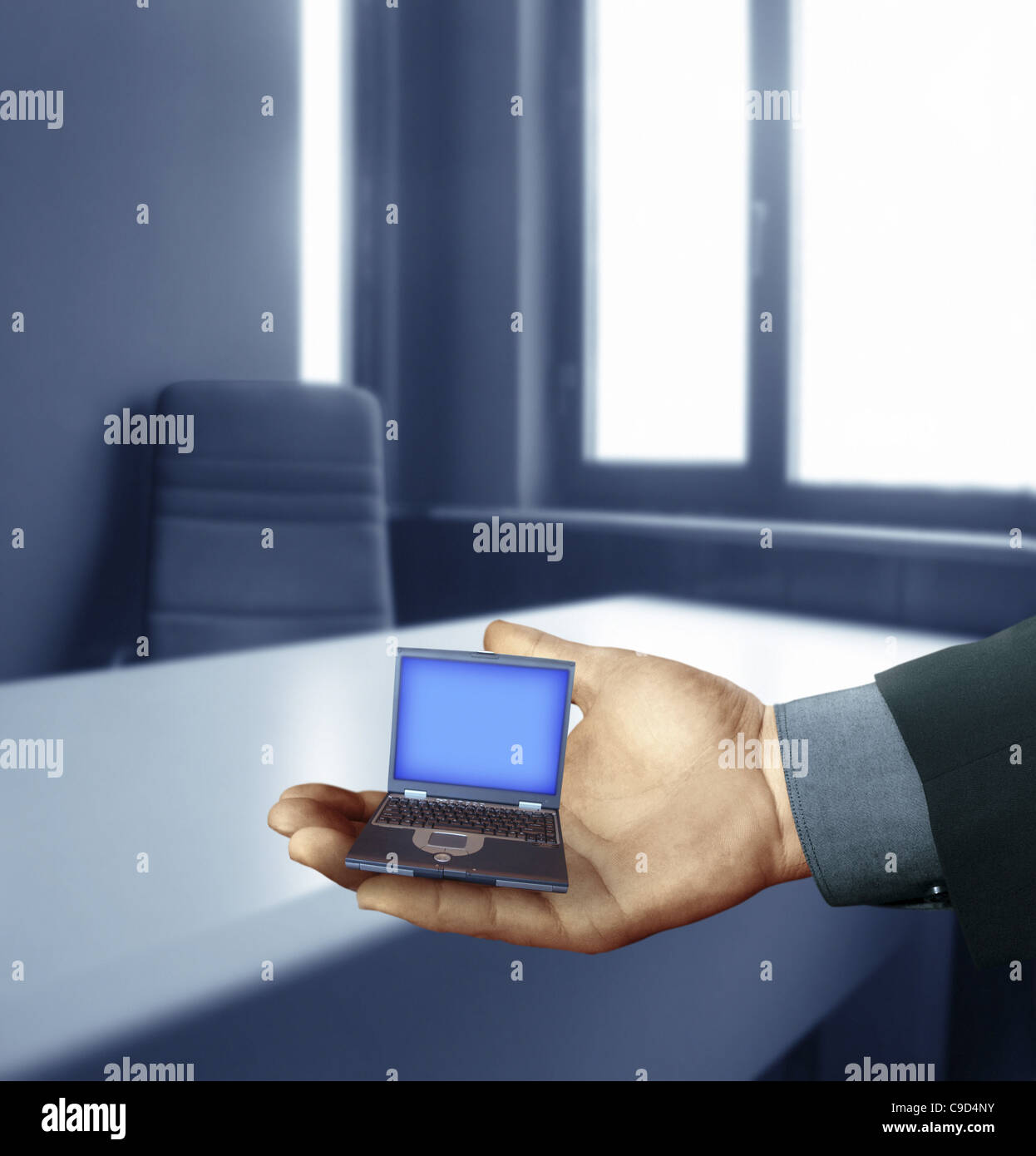 Person's hand holding a miniature laptop Stock Photo - Alamy