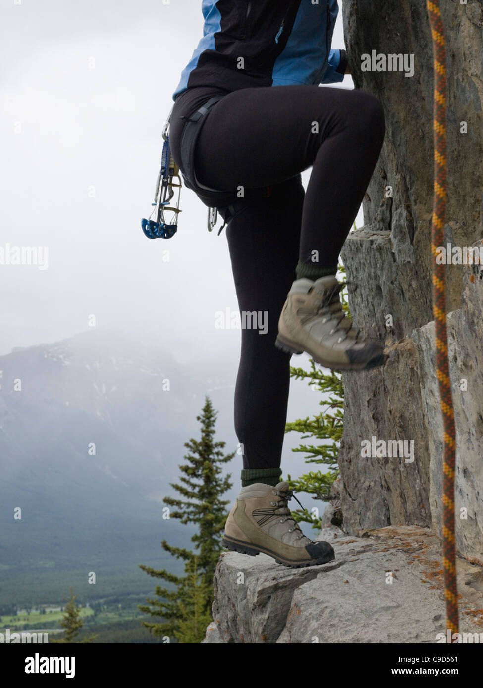 Canada, Alberta, Female climber climbing rock ledge, low section Stock ...