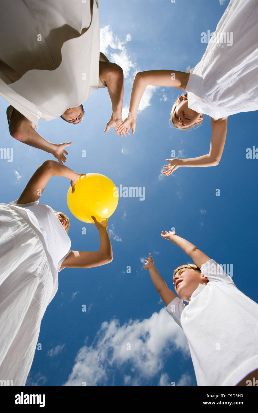 Children playing yellow ball together hi-res stock photography and ...