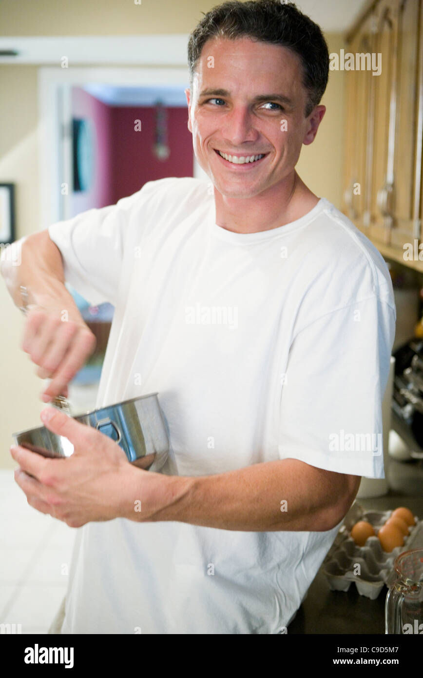 Man with mixing bowl Stock Photo - Alamy