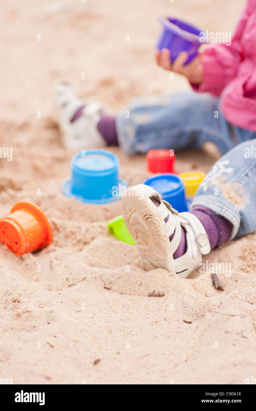 Baby girl, playing in the sand Stock Photo - Alamy