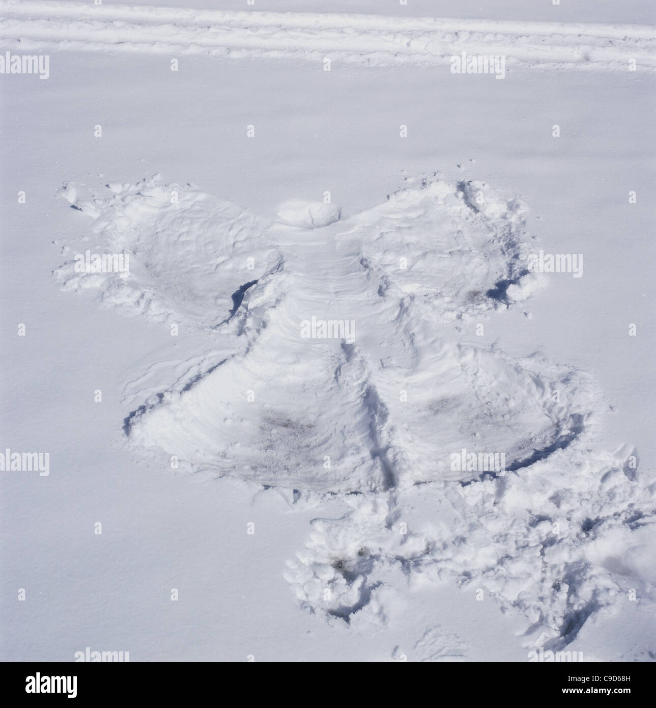 Snow angel on the ground Stock Photo - Alamy