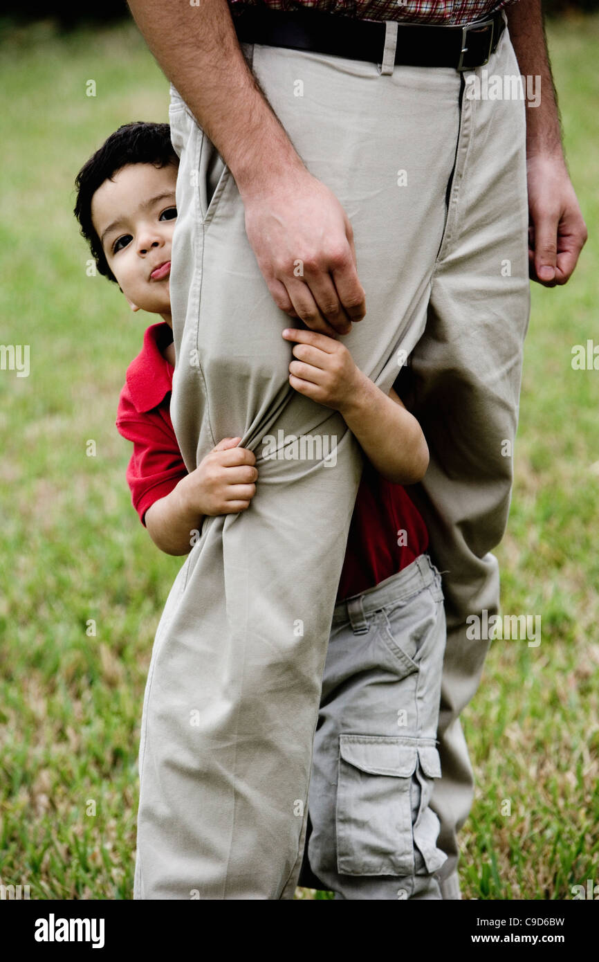 Portrait of a son holding his father by his leg Stock Photo - Alamy