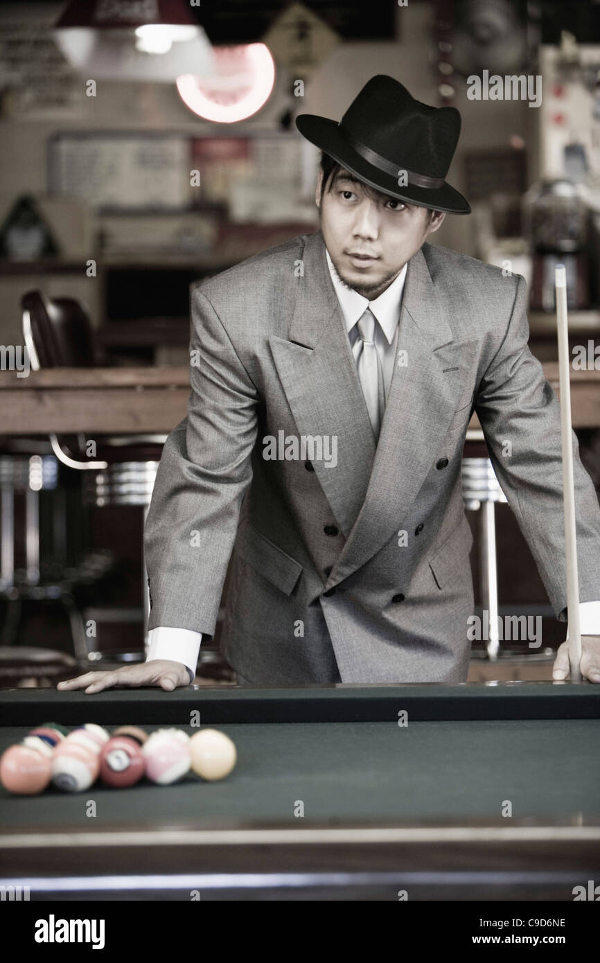 Asian man in pool hall Stock Photo - Alamy