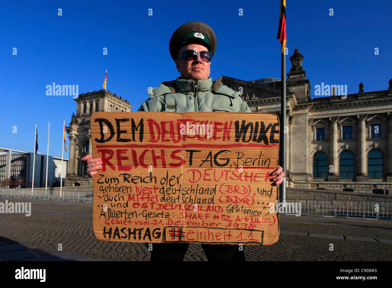 A man holds a placard demanding historic rights for areas in Eastern ...