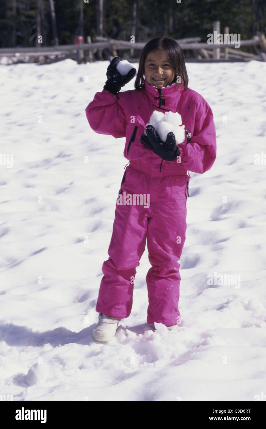 Portrait of a girl throwing snowballs Stock Photo - Alamy