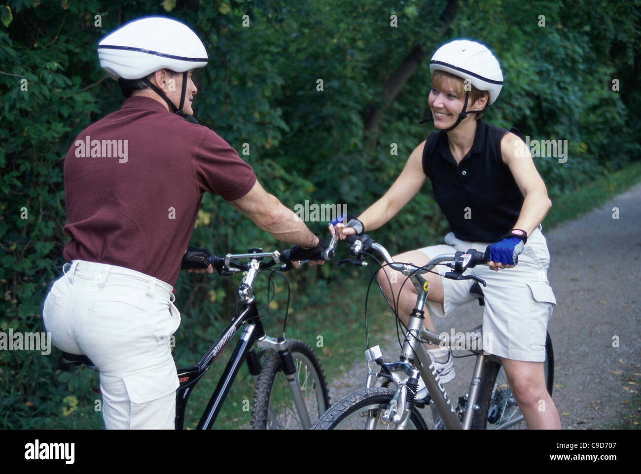 Mid adult couple riding bicycles Stock Photo - Alamy