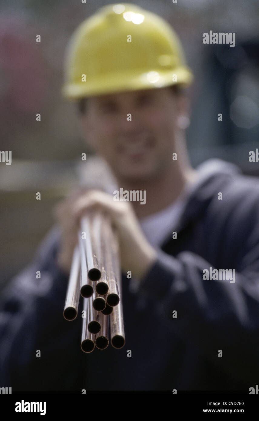 Construction worker carrying pipes hi-res stock photography and images ...