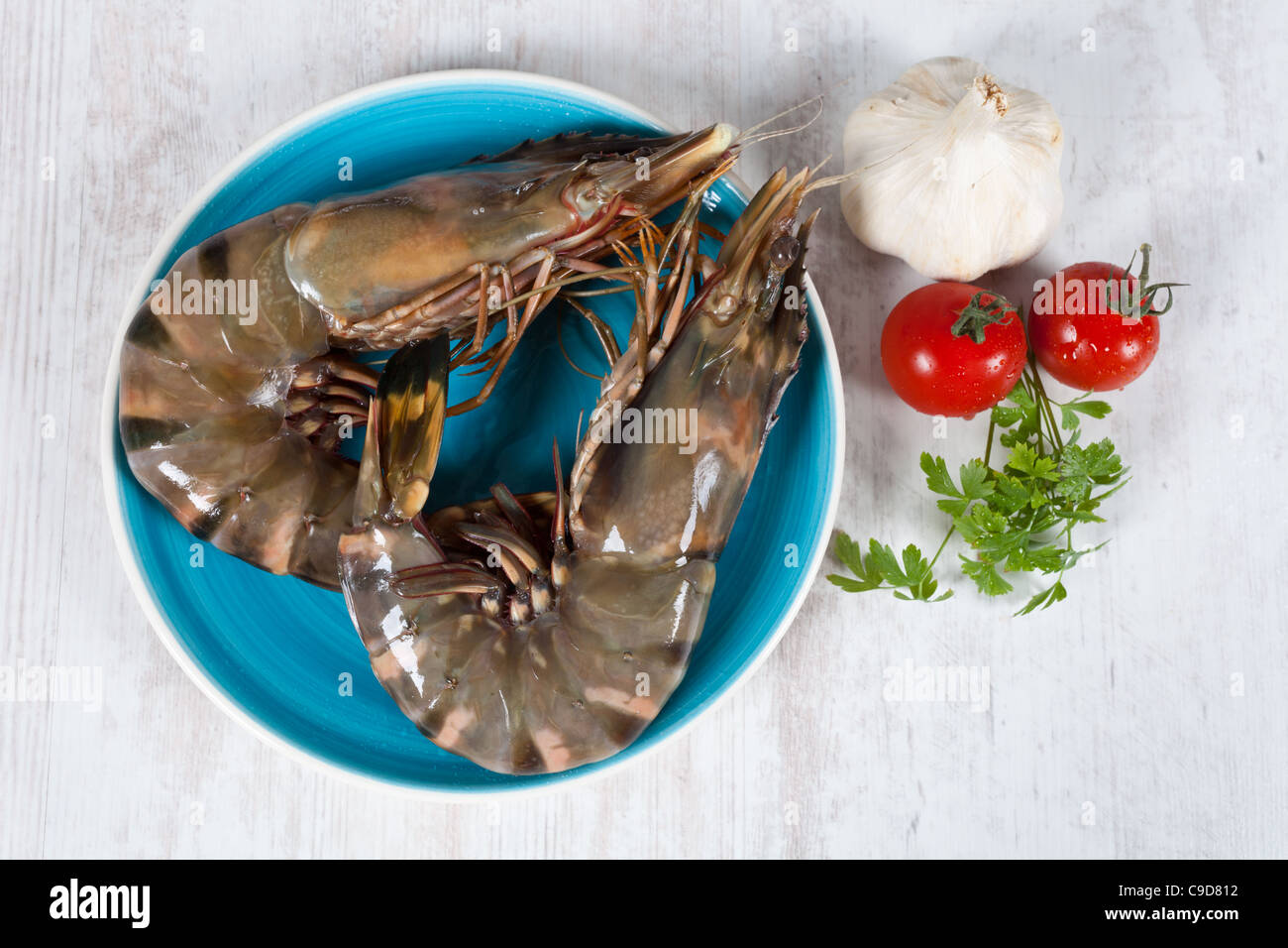 Fresh raw big prawns on a blue plate Stock Photo - Alamy