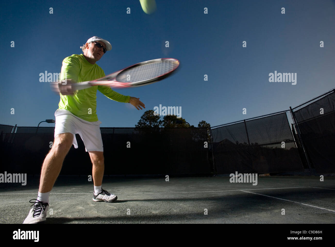 Tennis player hitting a backhand Stock Photo - Alamy