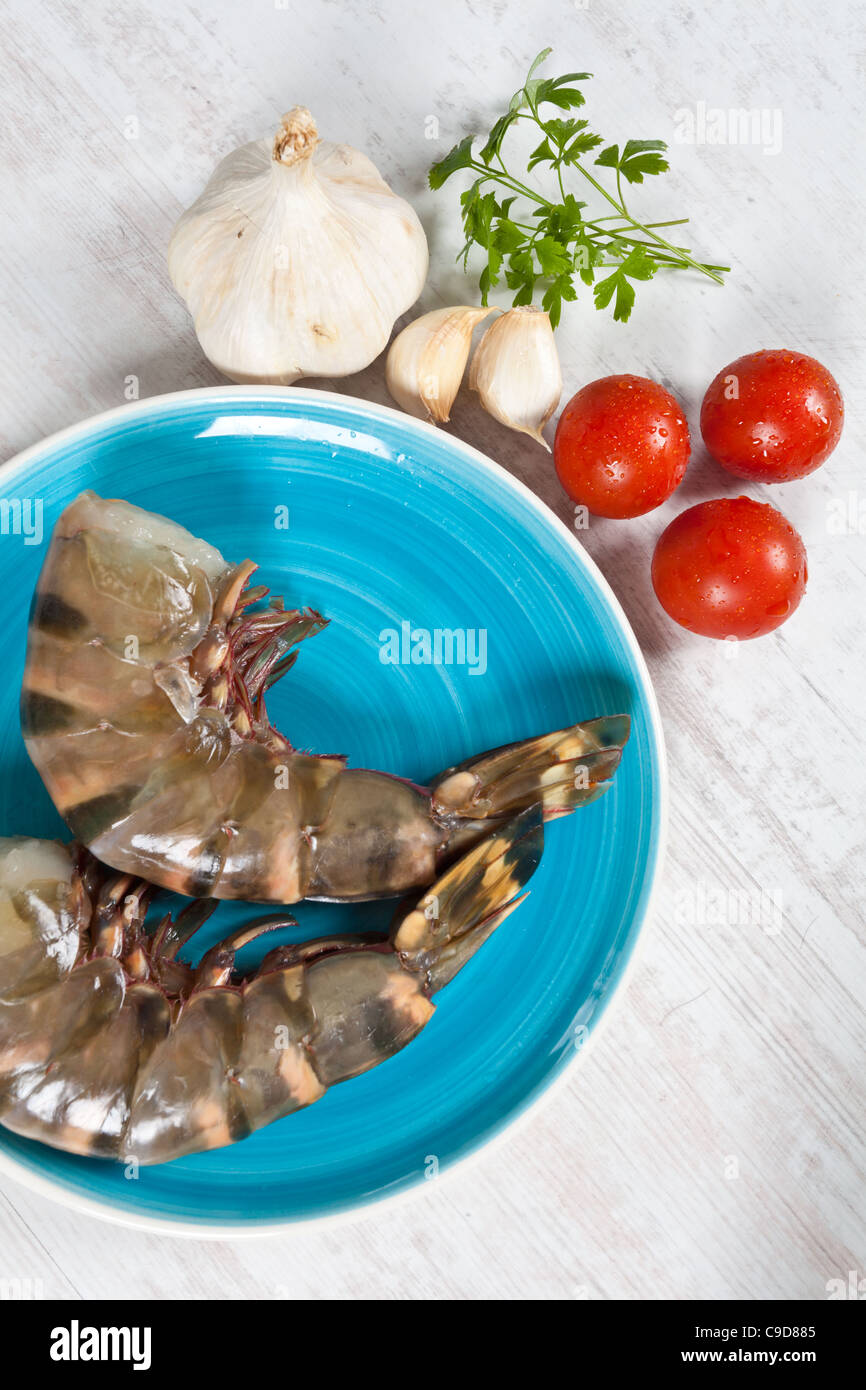 Fresh raw big prawn tails on blue plate Stock Photo - Alamy