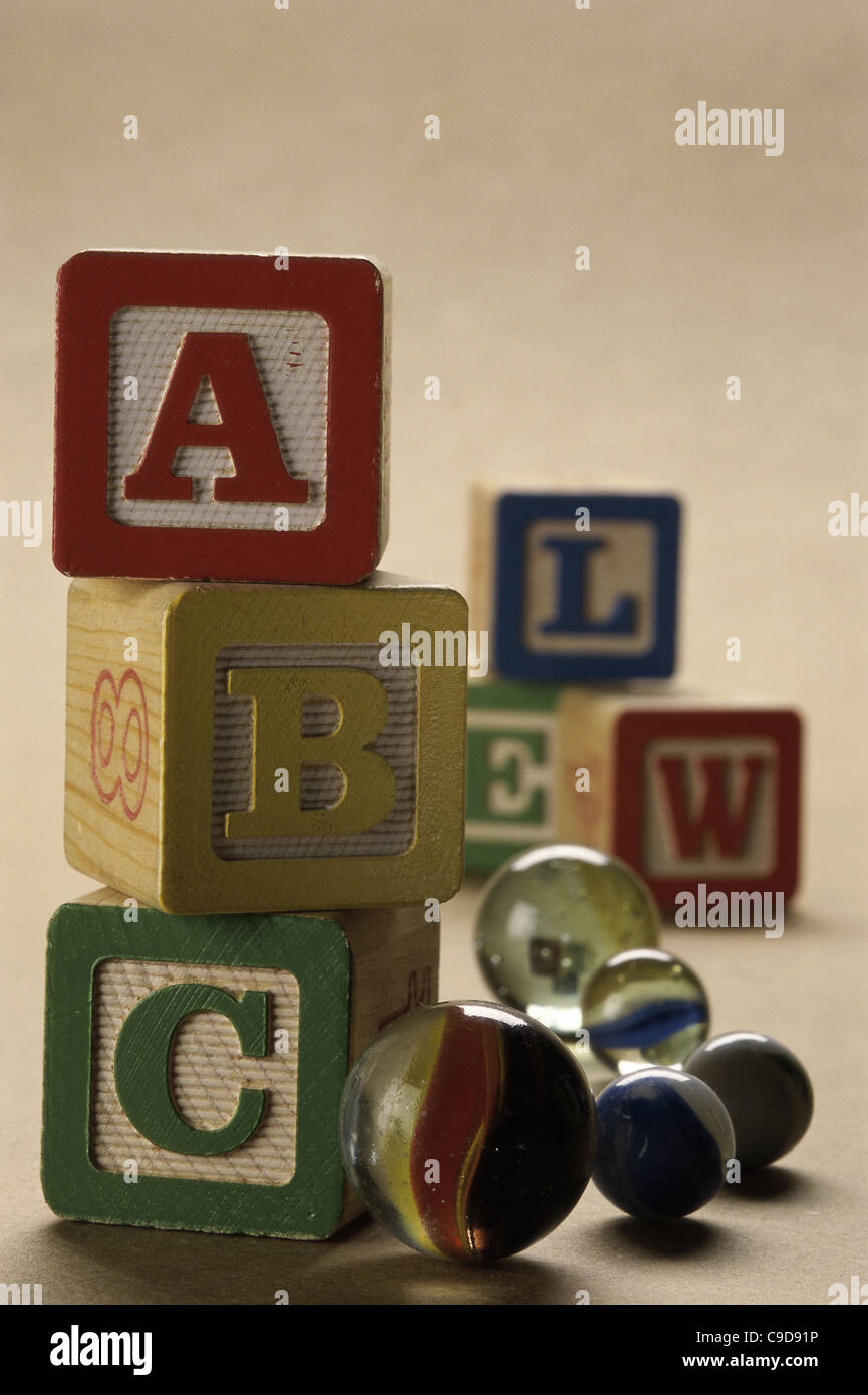 Close-up of alphabet building blocks and marbles Stock Photo - Alamy