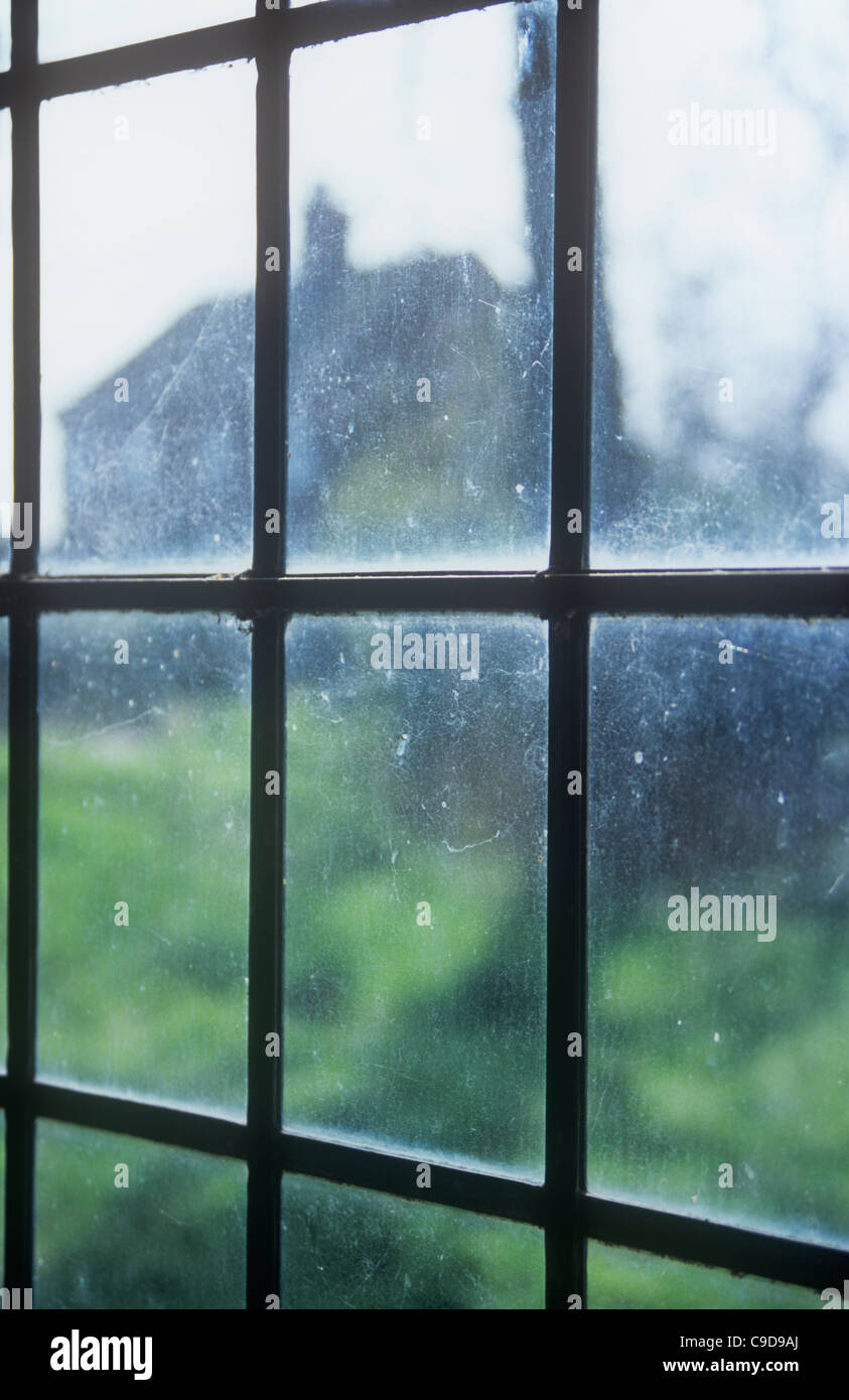 House with a chimney viewed through a window, England Stock Photo - Alamy
