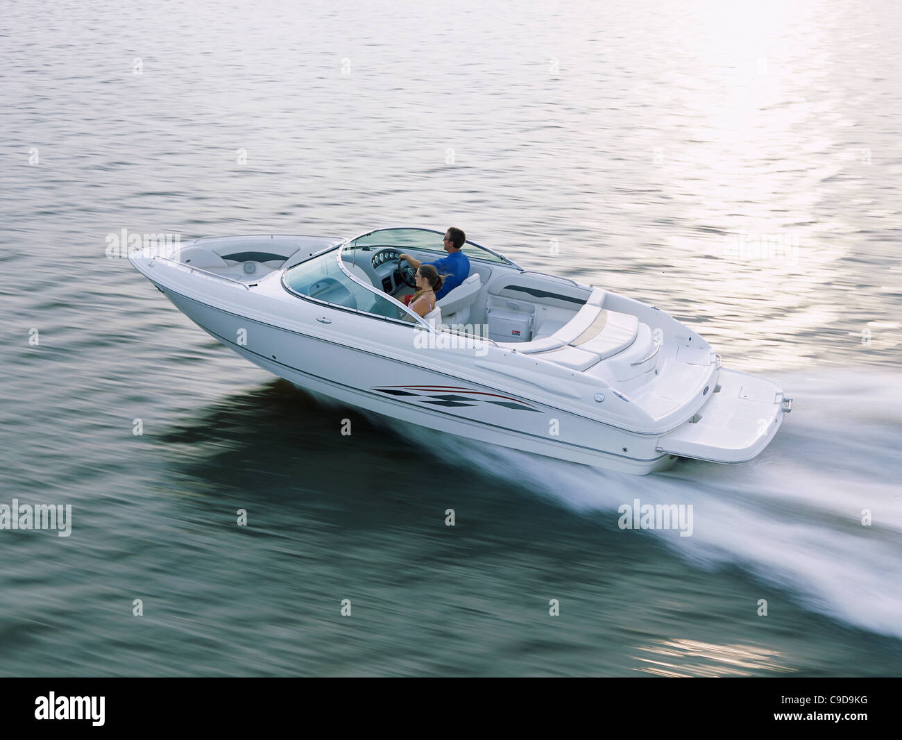 Two people in a motorboat Stock Photo - Alamy