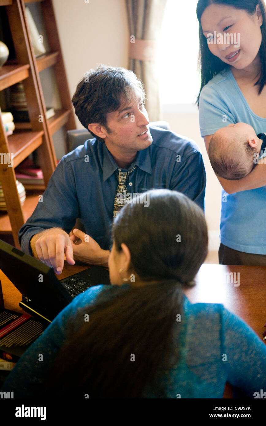 Family using laptop at home Stock Photo - Alamy