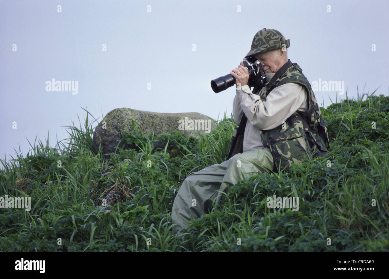 Photographer taking a snapshot outdoors Stock Photo - Alamy