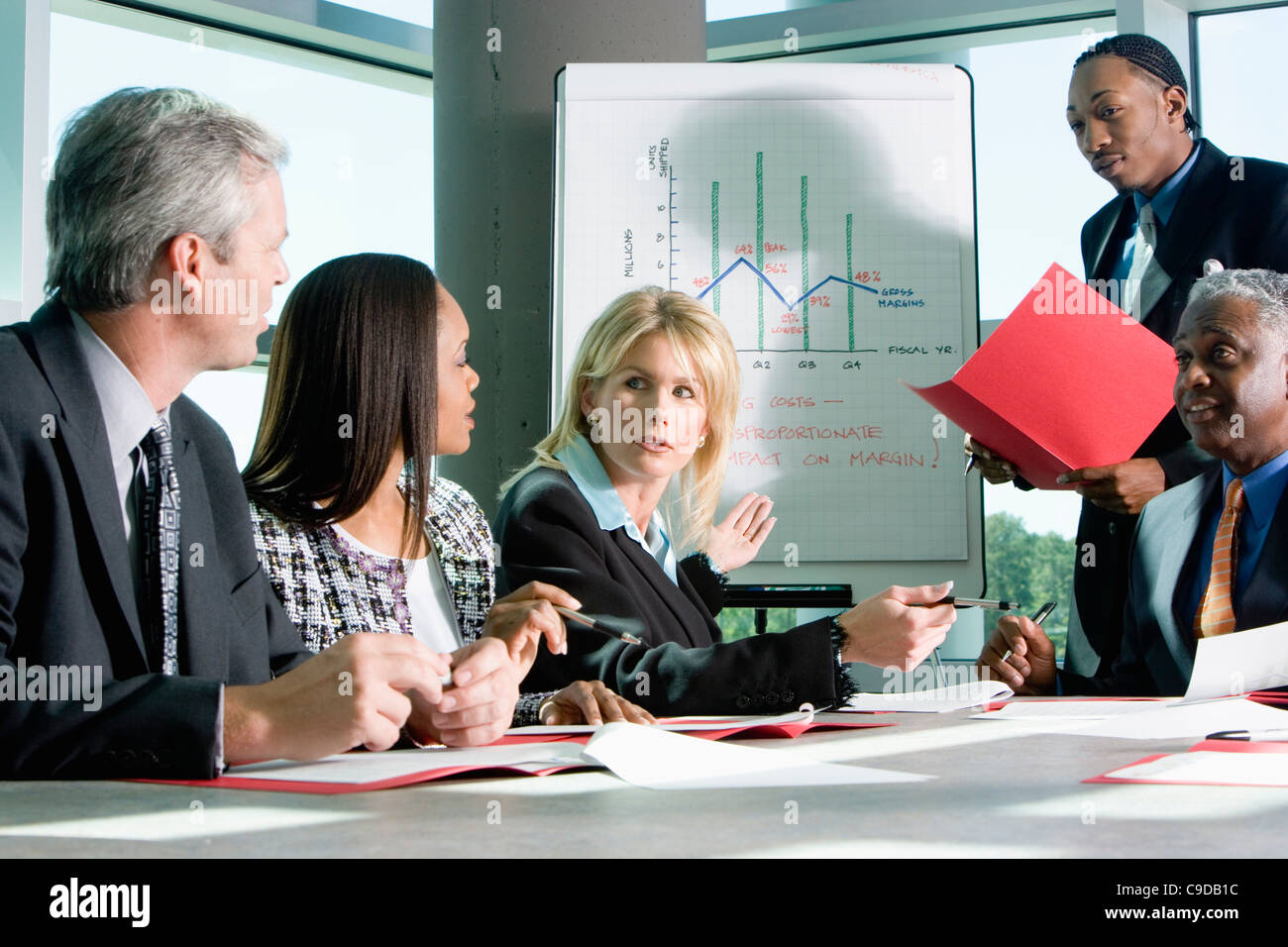 Businessman businesswomen discussing financial charts hi-res stock ...