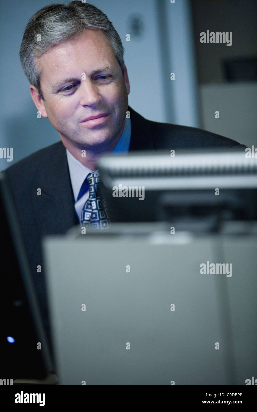 Close-up of businessman in front of computer monitor Stock Photo - Alamy