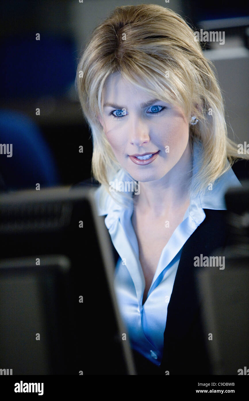 Close-up of business woman in front of computer monitor Stock Photo - Alamy