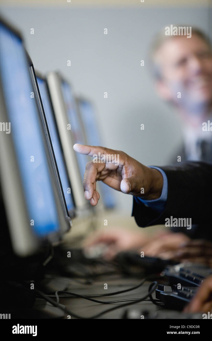 Close-up of a human hand pointing at computer screen Stock Photo - Alamy