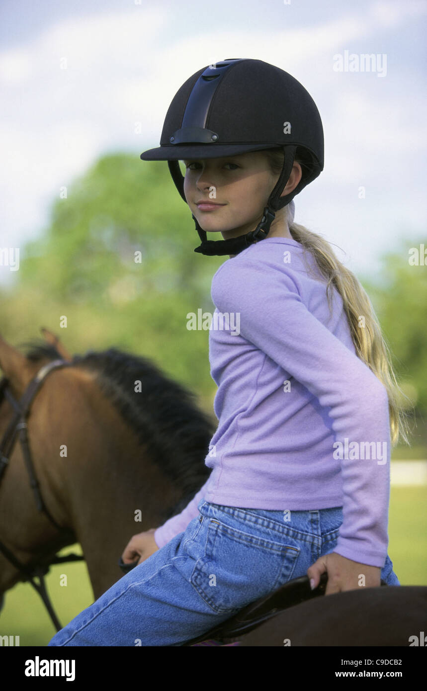 Portrait of a girl riding a Welsh pony Stock Photo - Alamy