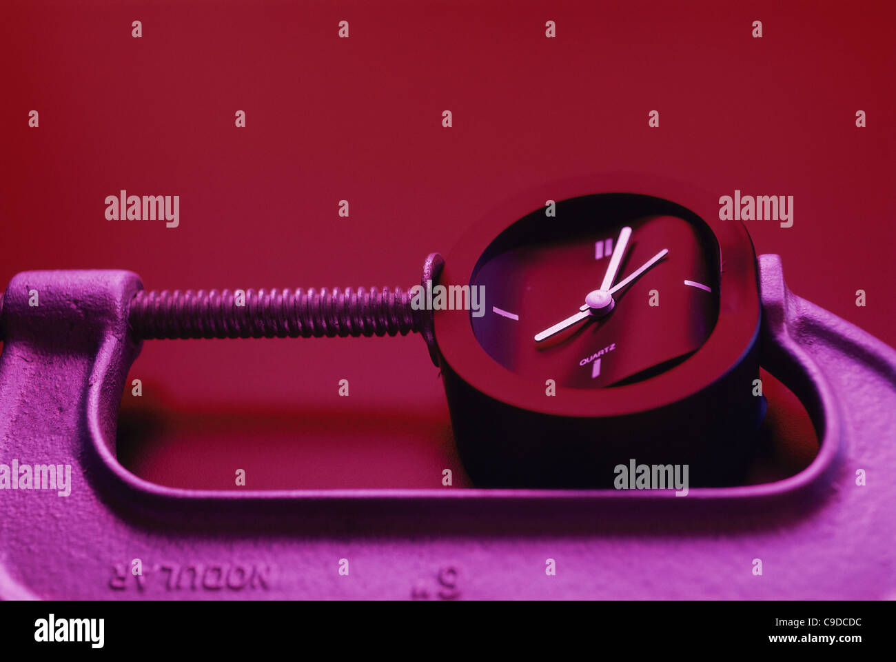 Close-up of a clock being squeezed in a clamp Stock Photo - Alamy