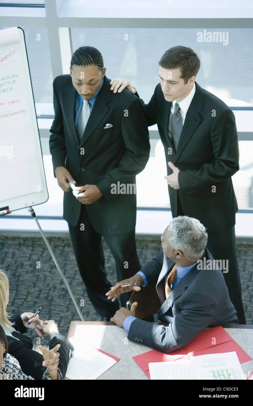 Two young businessmen giving presentation to executives Stock Photo - Alamy
