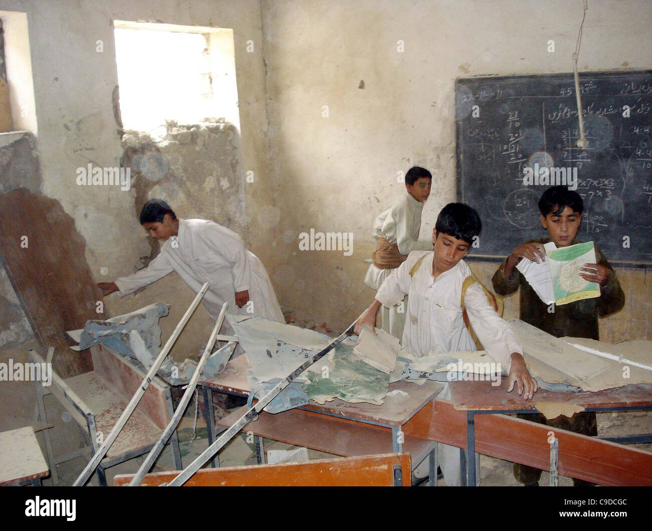 Students look a damaged classroom which was destroyed in explosion ...