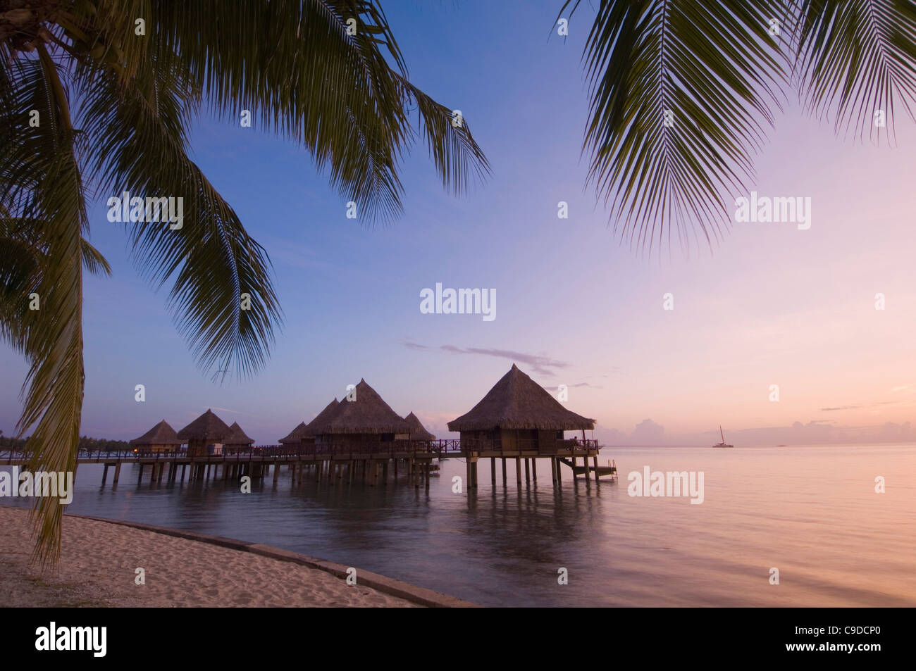 Stilt houses at a tourist resort on the beach, Hotel Kia Ora, Rangiroa ...