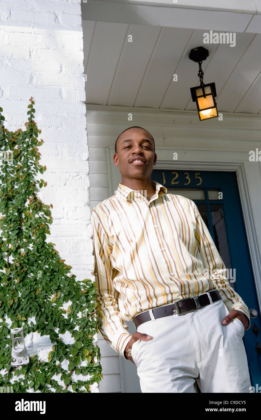 Portrait of a young man standing outside a house Stock Photo - Alamy