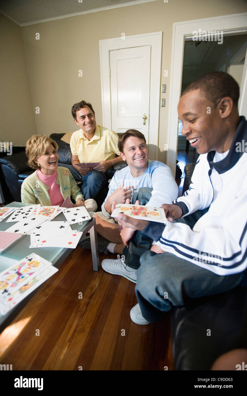 People playing cards in a living room Stock Photo - Alamy