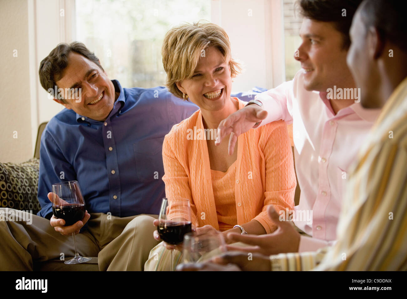 Parents chatting with adult son and friend Stock Photo - Alamy