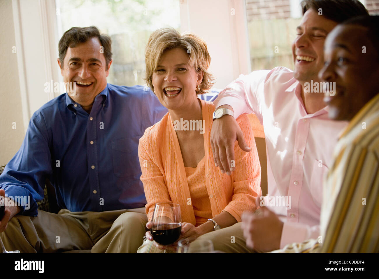 Parents chatting with adult son and friend Stock Photo - Alamy